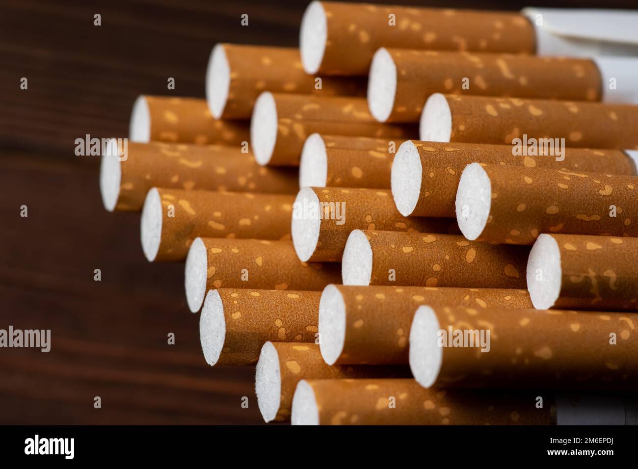 image of several commercially made cigarettes. pile cigarette on wooden ...