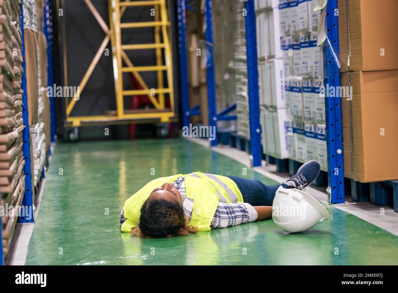 African black warehouse worker injured from accident Stock Photo - Alamy