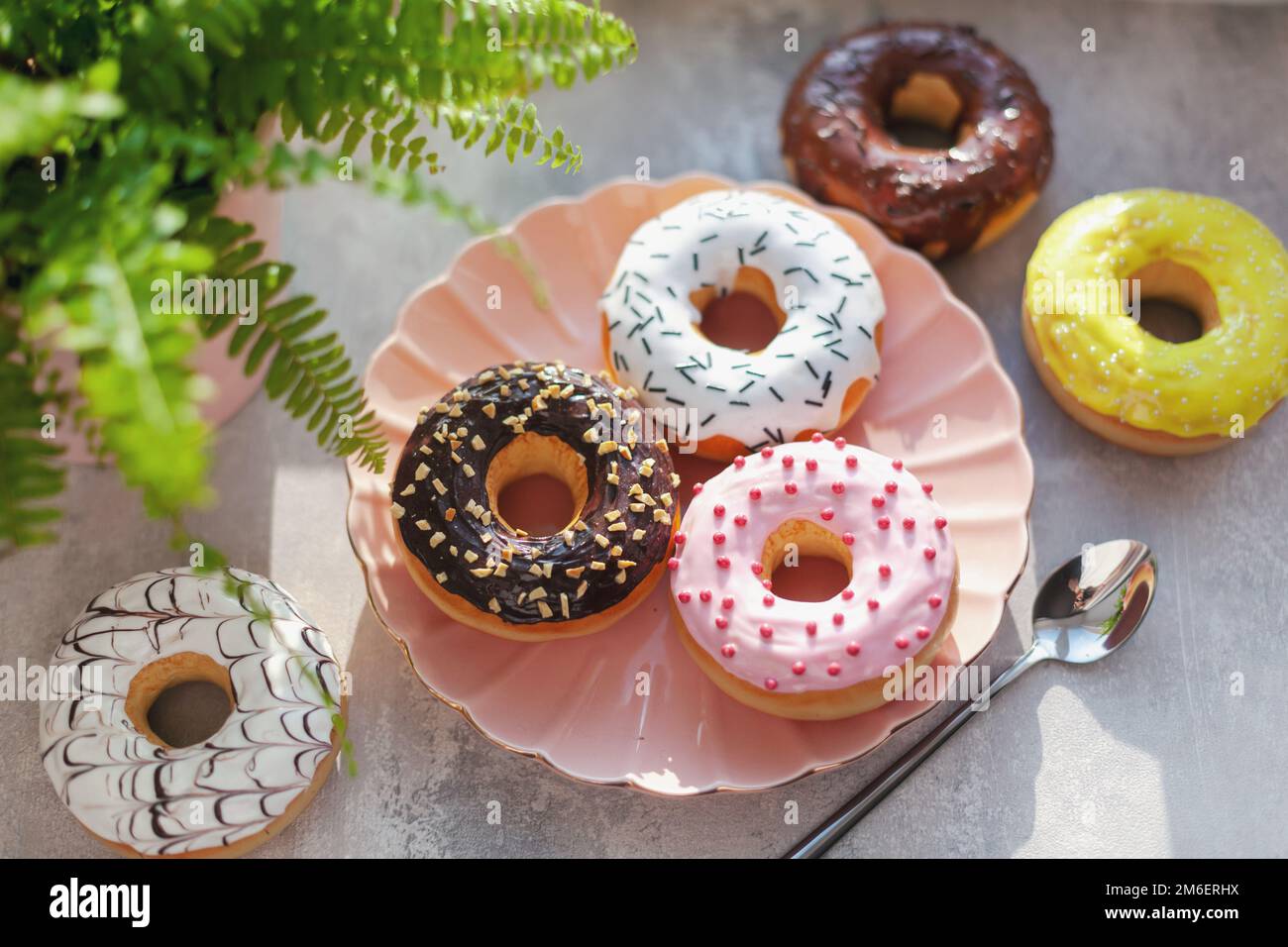 Colored different donuts with icing and topping Stock Photo - Alamy