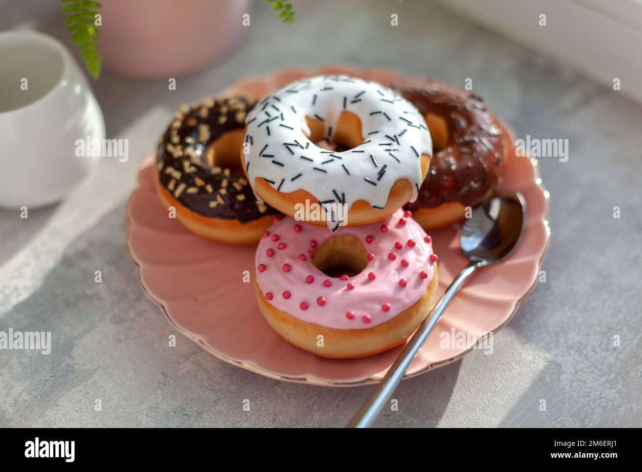 Colored different donuts with icing and topping Stock Photo - Alamy