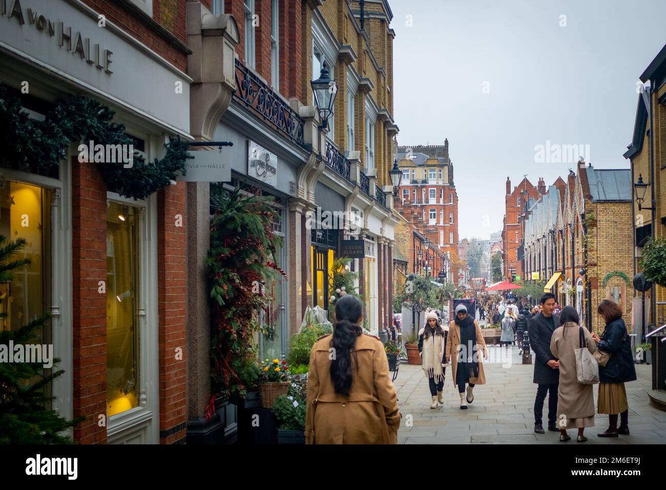 London- November 2022: Shoppers and shop window on Sloane Square, an up ...