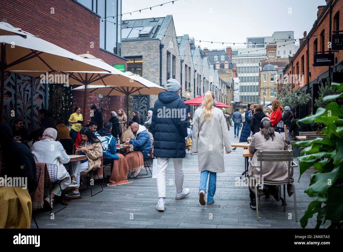 London- November 2022: Shoppers and shop window on Sloane Square, an up ...