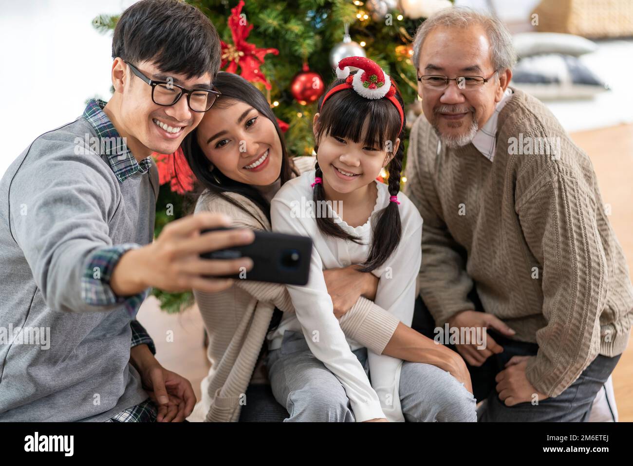 Multigenerational Family selfie with Christmas tree Stock Photo - Alamy