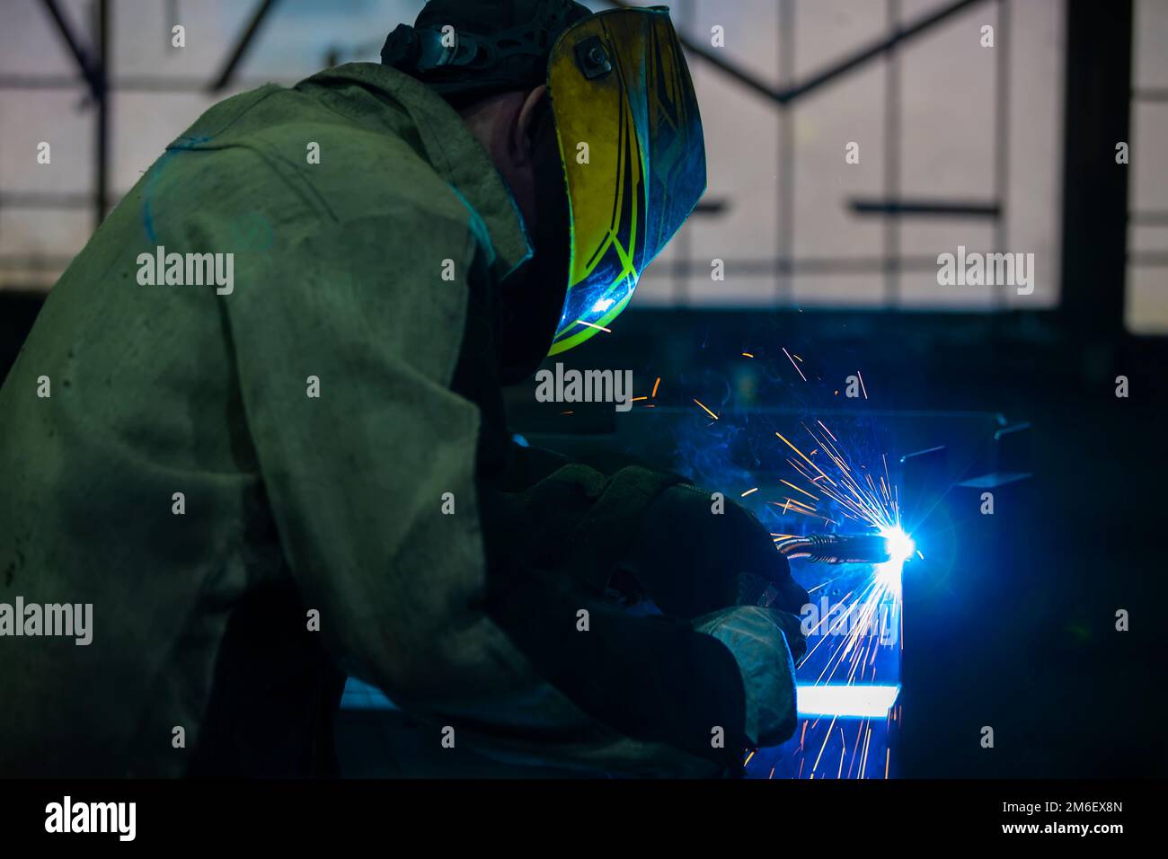 A welder works with metal in a factory shop Stock Photo - Alamy
