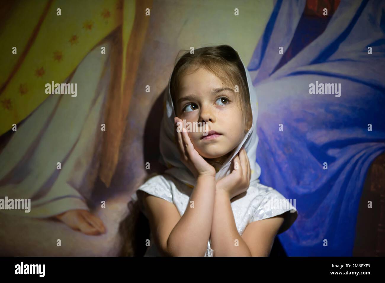 Little girl in a headscarf in the church. Child and religion concept ...