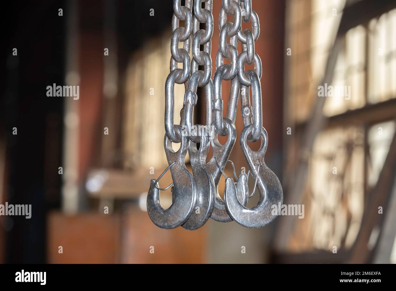 Metal chains with hooks in the workshop of a metallurgical plant Stock ...