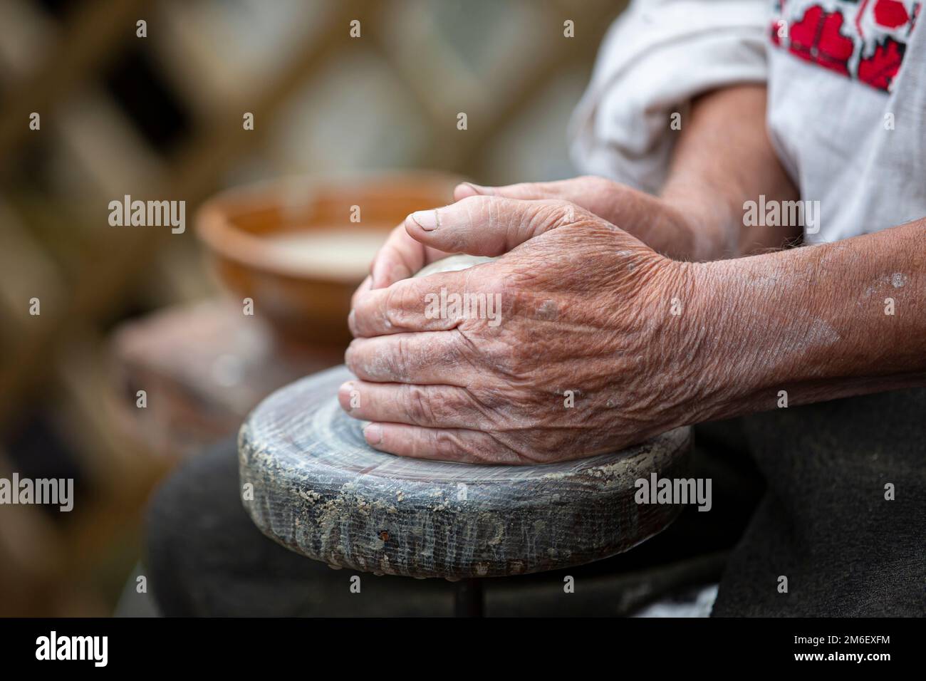 The old hands of the master make products from clay. Work on the potter ...