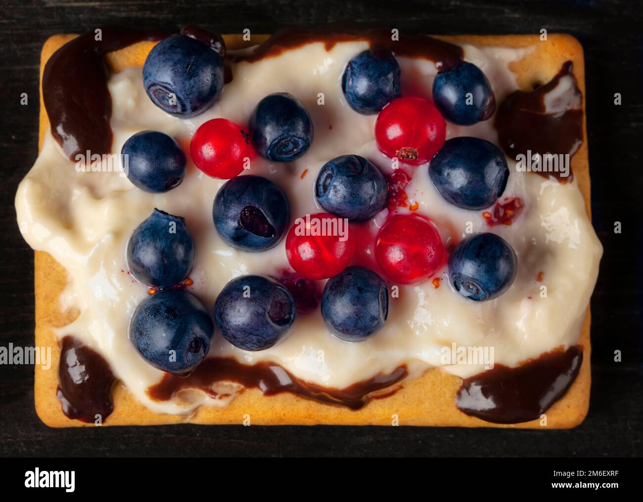 Square berry dessert for a buffet with blueberries and currants ...