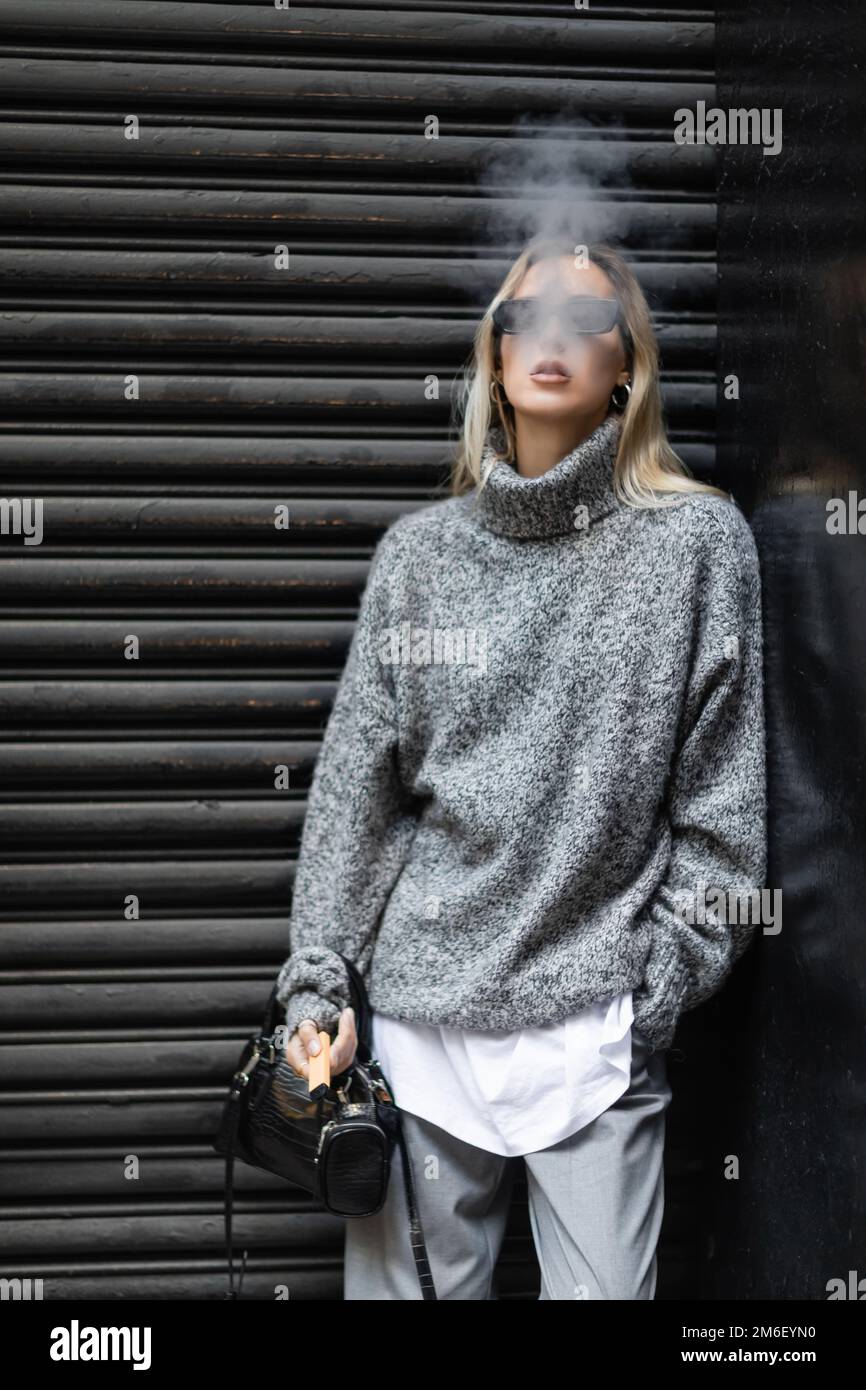 Young blonde woman smoking cigarette hi-res stock photography and ...