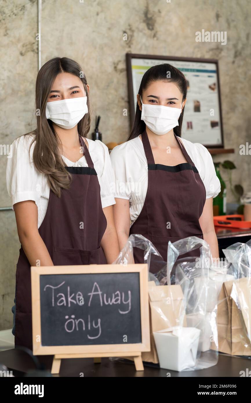 Waitress wear protective face mask with take away food Stock Photo - Alamy