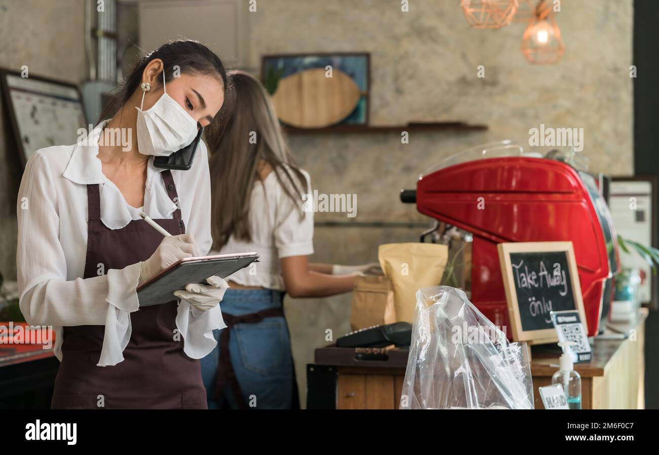 Waitress with face mask take order for curbside pick up and takeout ...