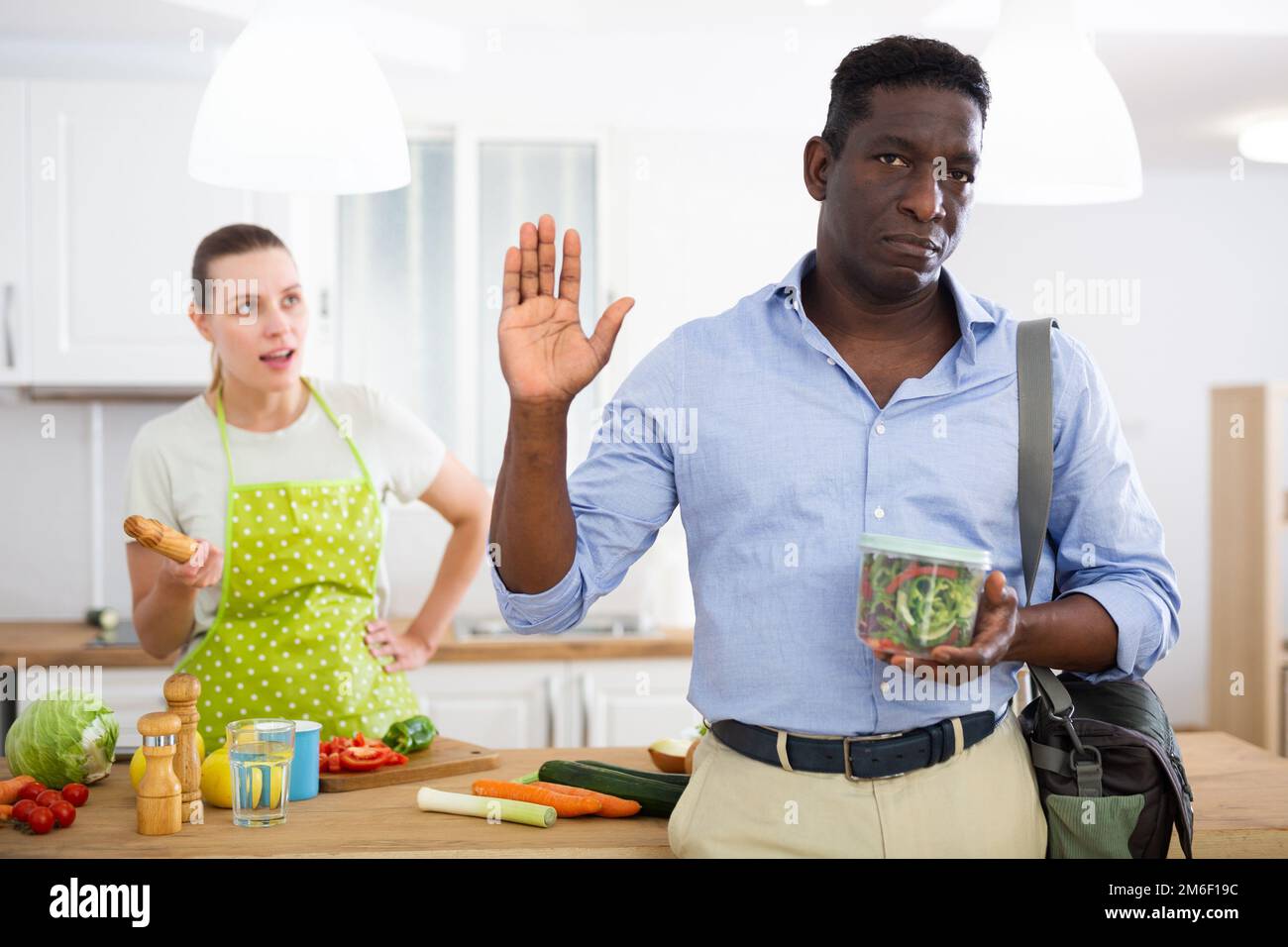 Upset husband going to work with lunch box Stock Photo - Alamy