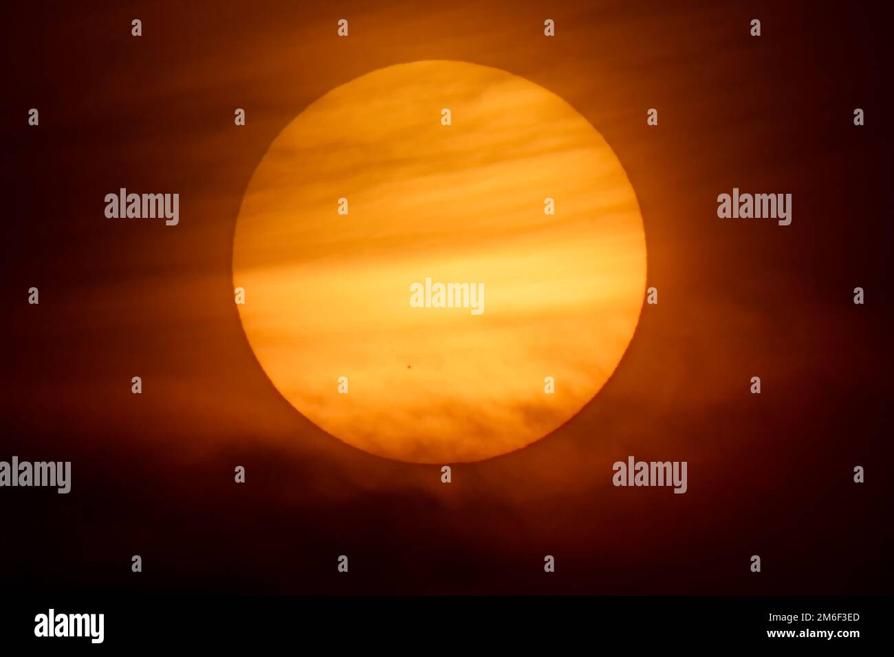 The sun and the sun set off behind the clouds Stock Photo - Alamy