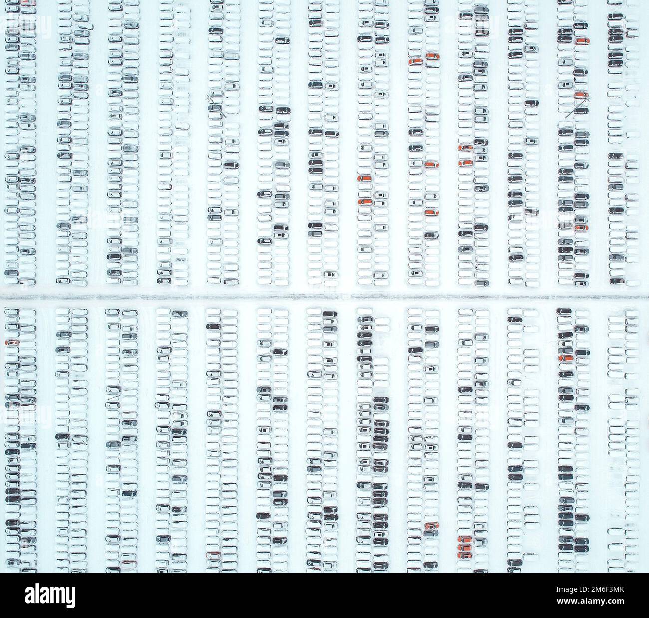 Cars under the snow at the car dealership. View from above at large ...