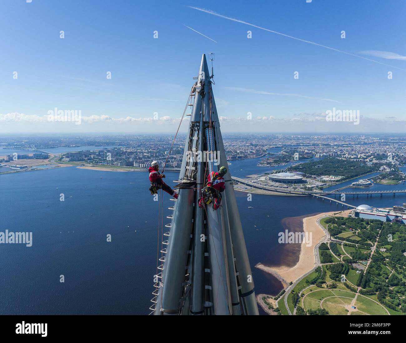 Workers installers at the height work at the top of skyscraper Stock ...
