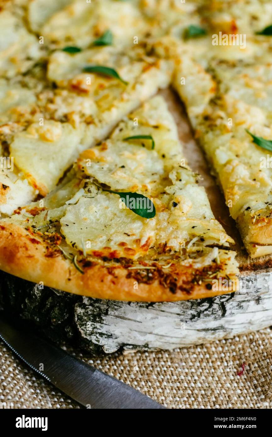 Slice of pizza separated from the main part of the pizza Stock Photo ...