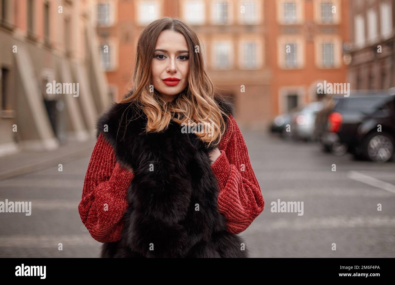 Outdoor photo of fashionable female model walking around city in winter ...