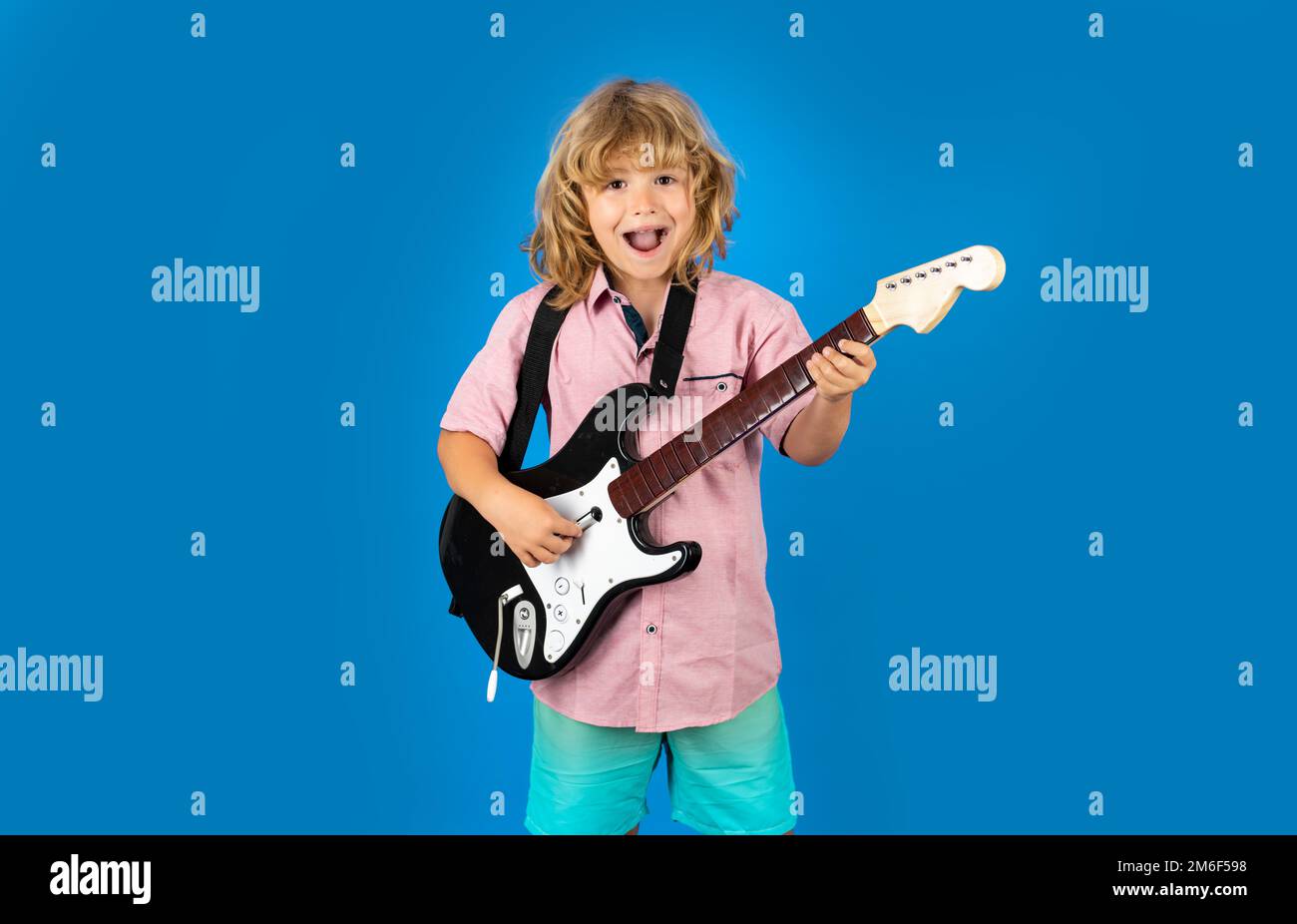 Fashion American country boy playing music. Happy smiling child ...