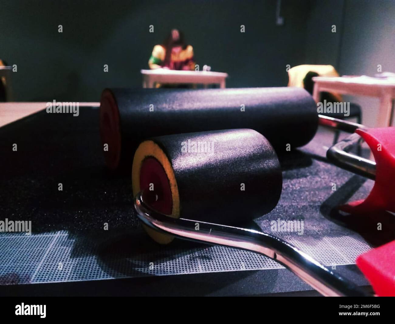 Rollers for painting in black paint. Painter tools Stock Photo - Alamy