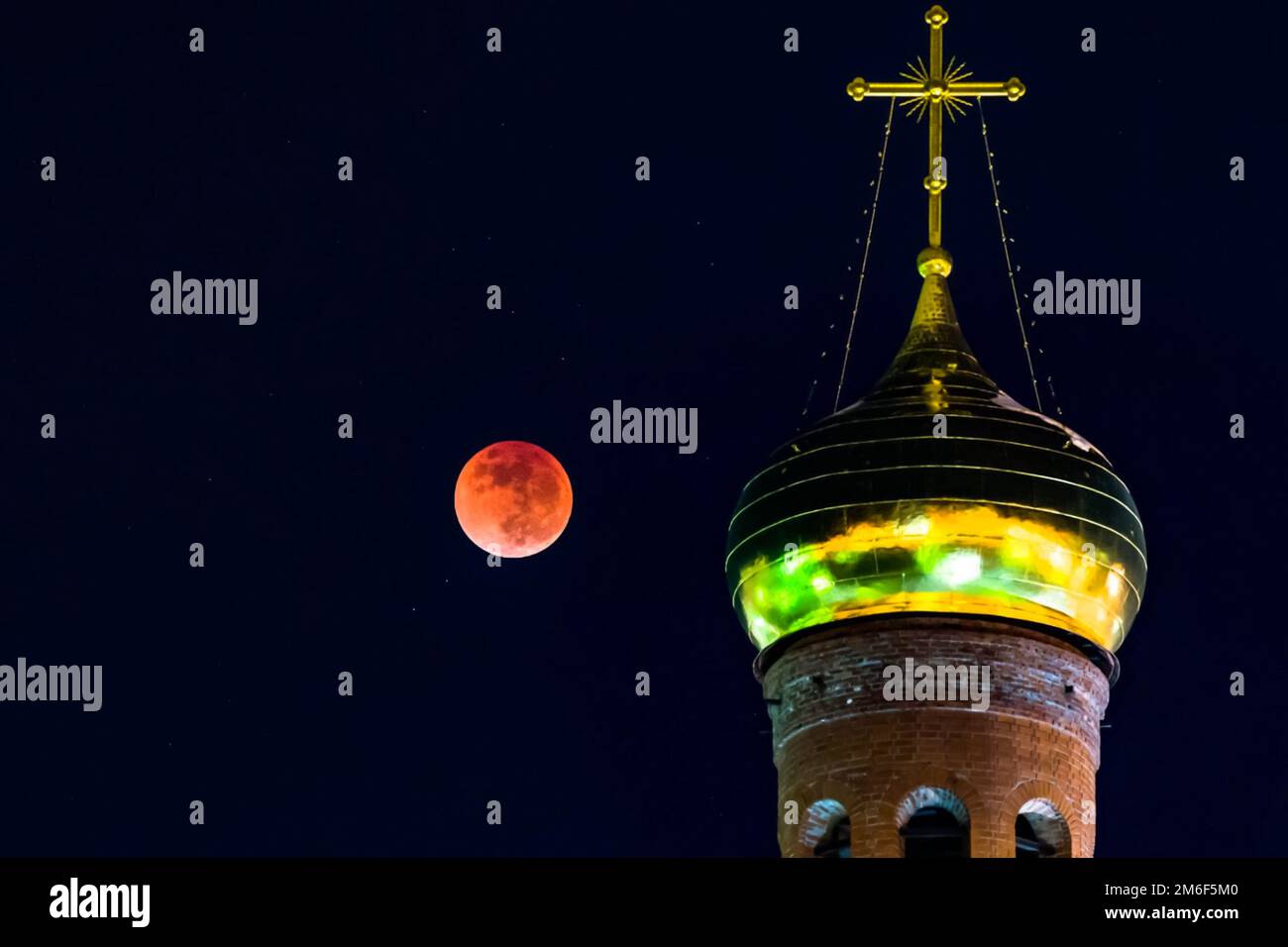 Dome of the church against the red moon. lunar eclipse Stock Photo - Alamy