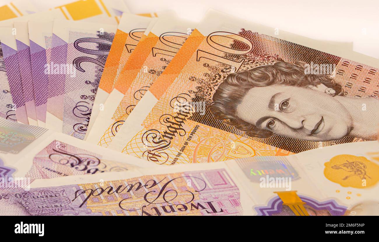 A pile of ten and twenty-pound notes against the white background Stock ...
