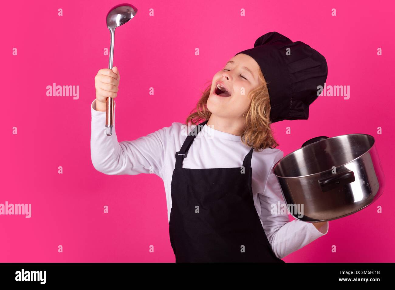 Child chef cook with cooking pot and ladle. Portrait of little child in ...