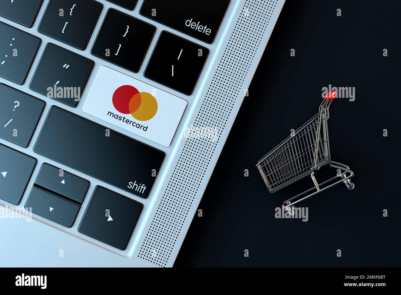 Mastercard logo on laptop keyboard and miniature shopping cart. 3D ...