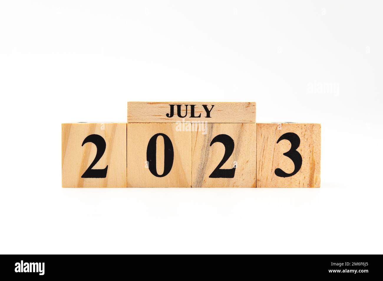 July 2023 written on wooden blocks isolated on white background with ...