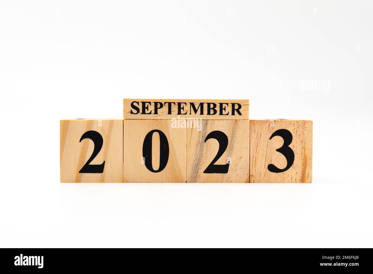 September 2023 written on wooden blocks isolated on white background ...