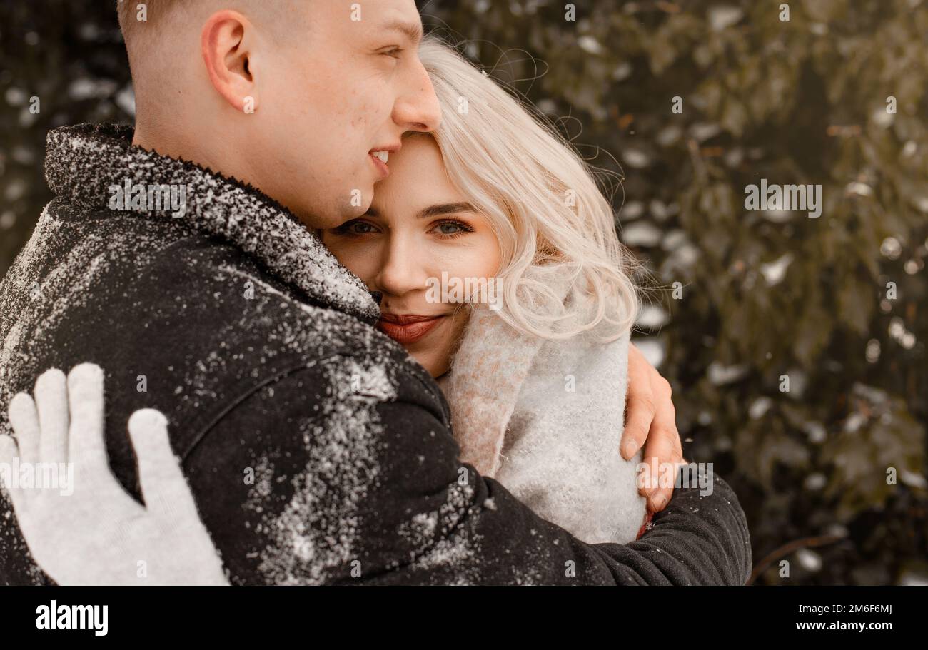 A loving couple in a gentle embrace. The guy kisses his girlfriend ...