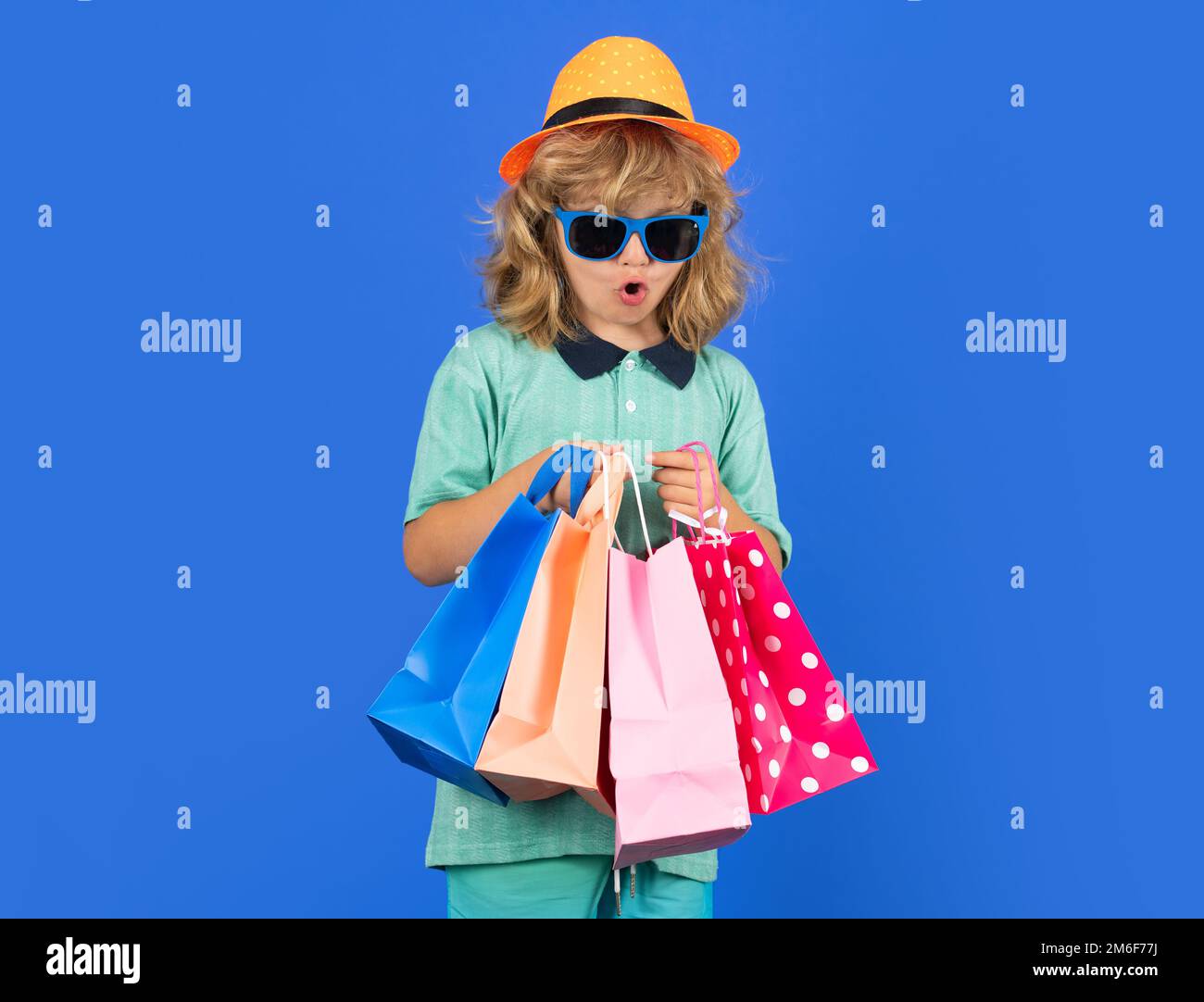 Fashion kid with shopping bag in studio. Little shopper child Stock ...