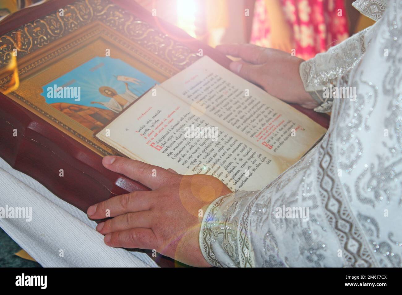 Close up of priest reading the holy bible. Priest during christening ...