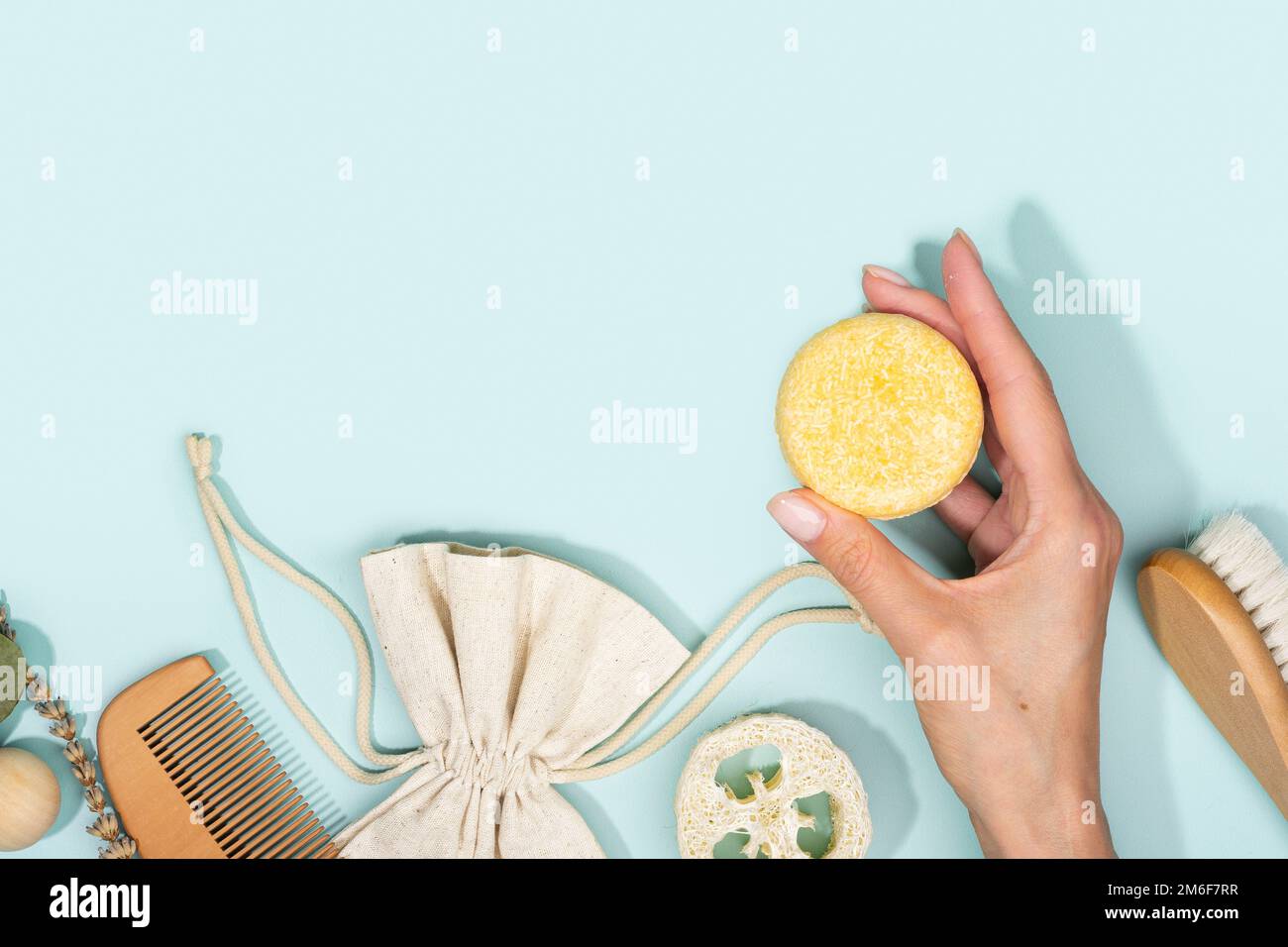 Female hand with solid shampoo bar. Bath accessories lying on a light ...
