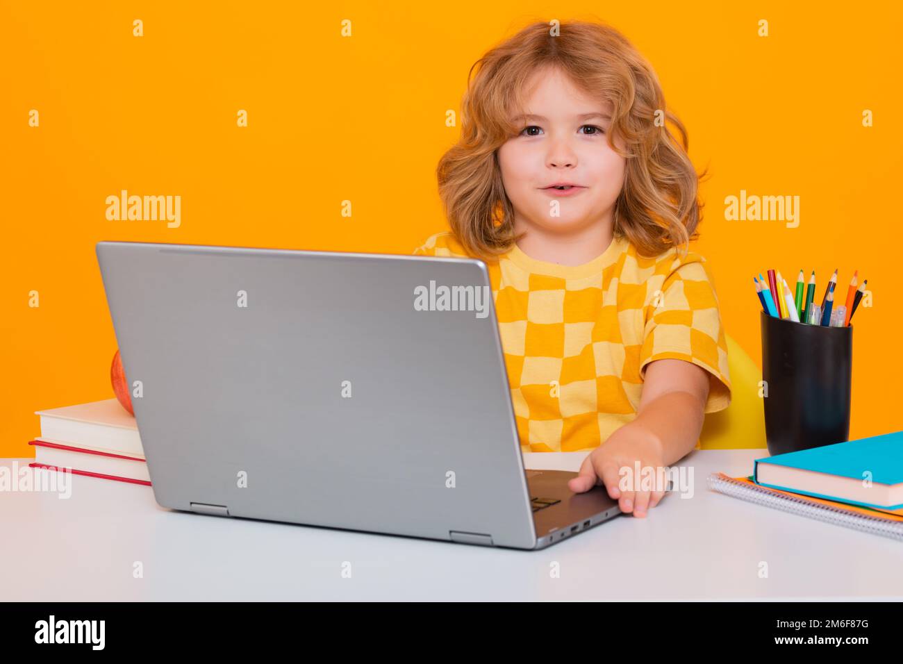 Cute school child using laptop computer. School kids. Child from ...