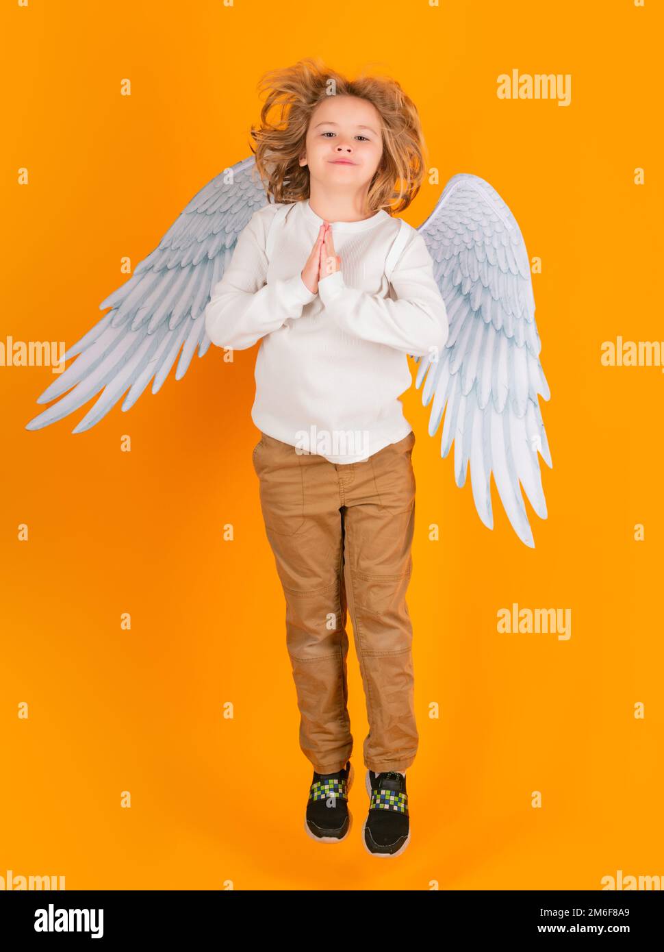 Little angel jump, kids jumping, full body. Valentine's day. Blonde ...