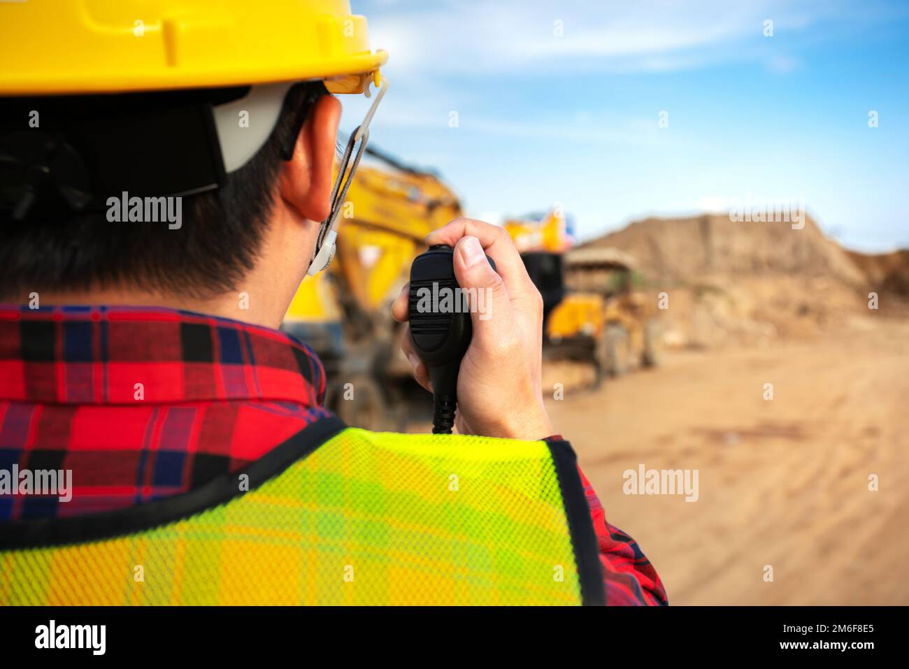 asian technician civil engineer talk with team by walkie talkie and ...