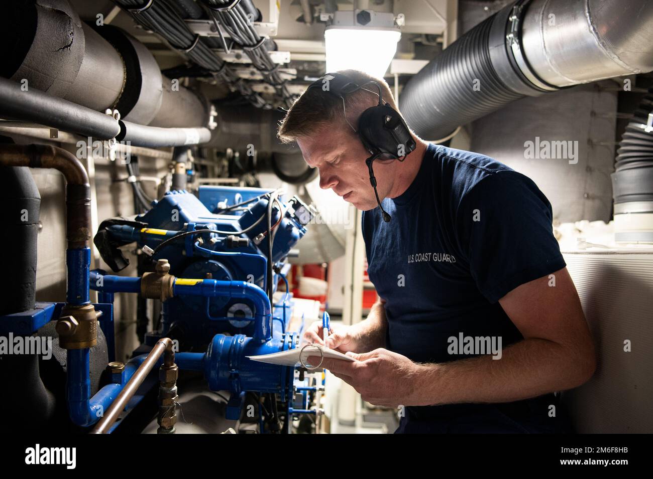 A Coast Guard Cutter Daniel Tarr engineer of the watch conducts a round ...