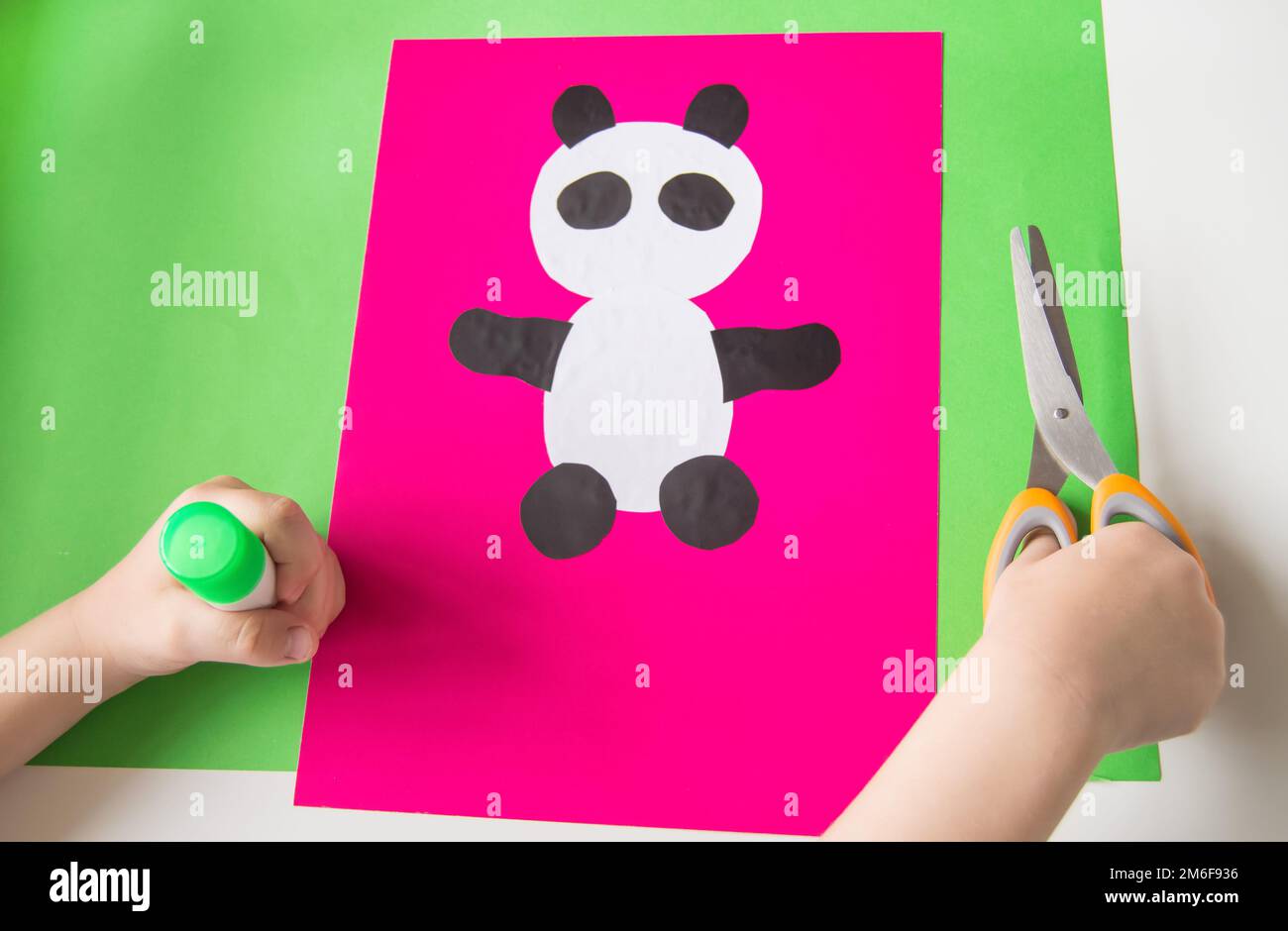 Step 5. The child glued the Panda's paws. The concept of DIY and ...