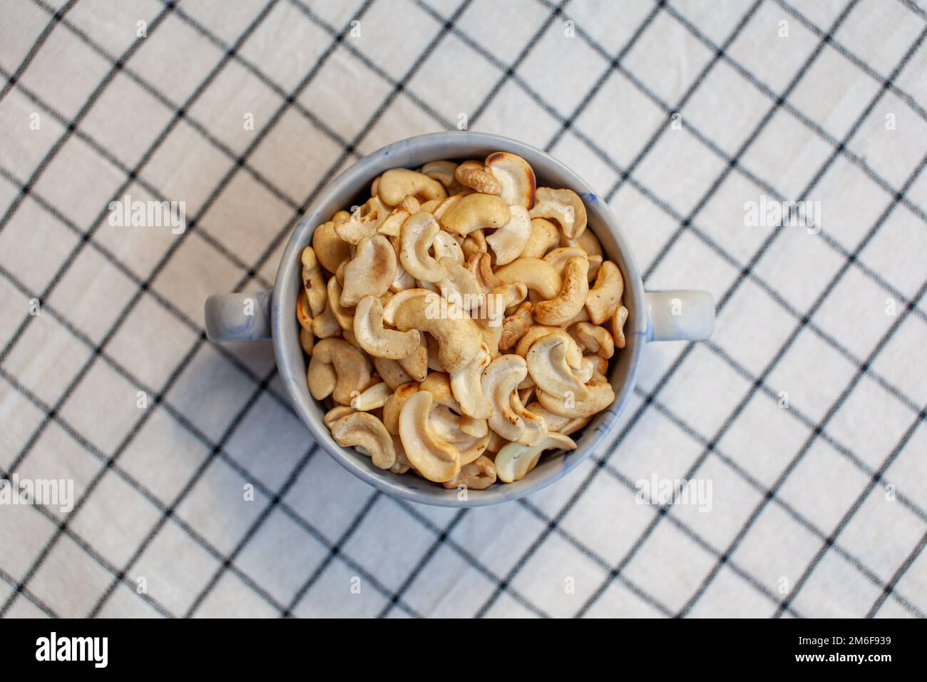 A plate of cashew nuts on a nice napkin. Delicious and healthy food ...