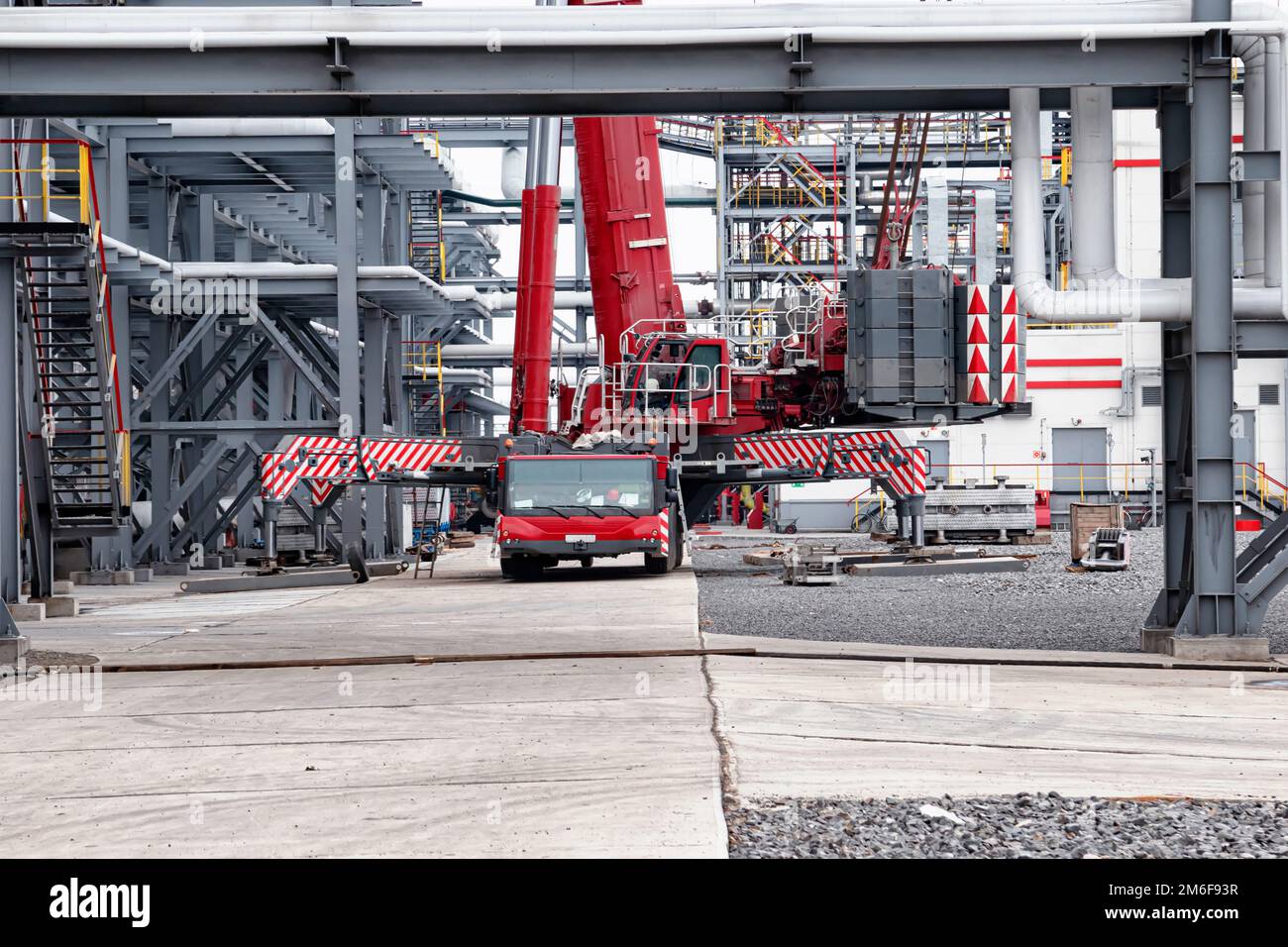 Huge truck crane at the oil plant with a high boom at the oil refinery ...