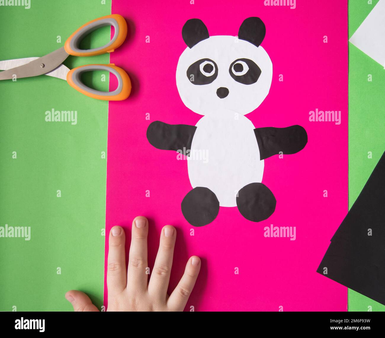 Step 6. the Child glued the Panda's ears and eyes. The concept of DIY ...