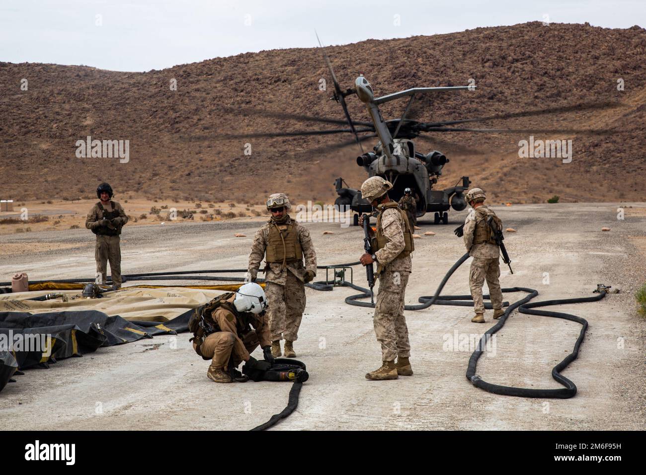 U.S. Marines with Marine Wing Support Squadron (MWSS) 273, carry fuel ...