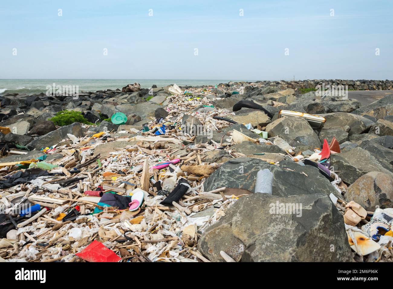 Spilled garbage on the beach near the big city. Empty used dirty ...