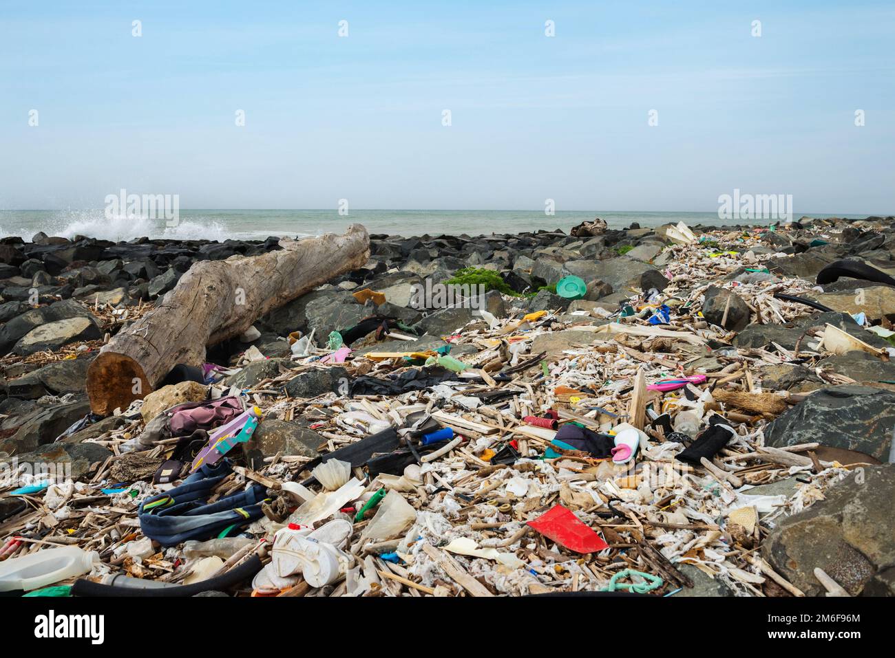 Spilled garbage on the beach near the big city. Empty used dirty ...