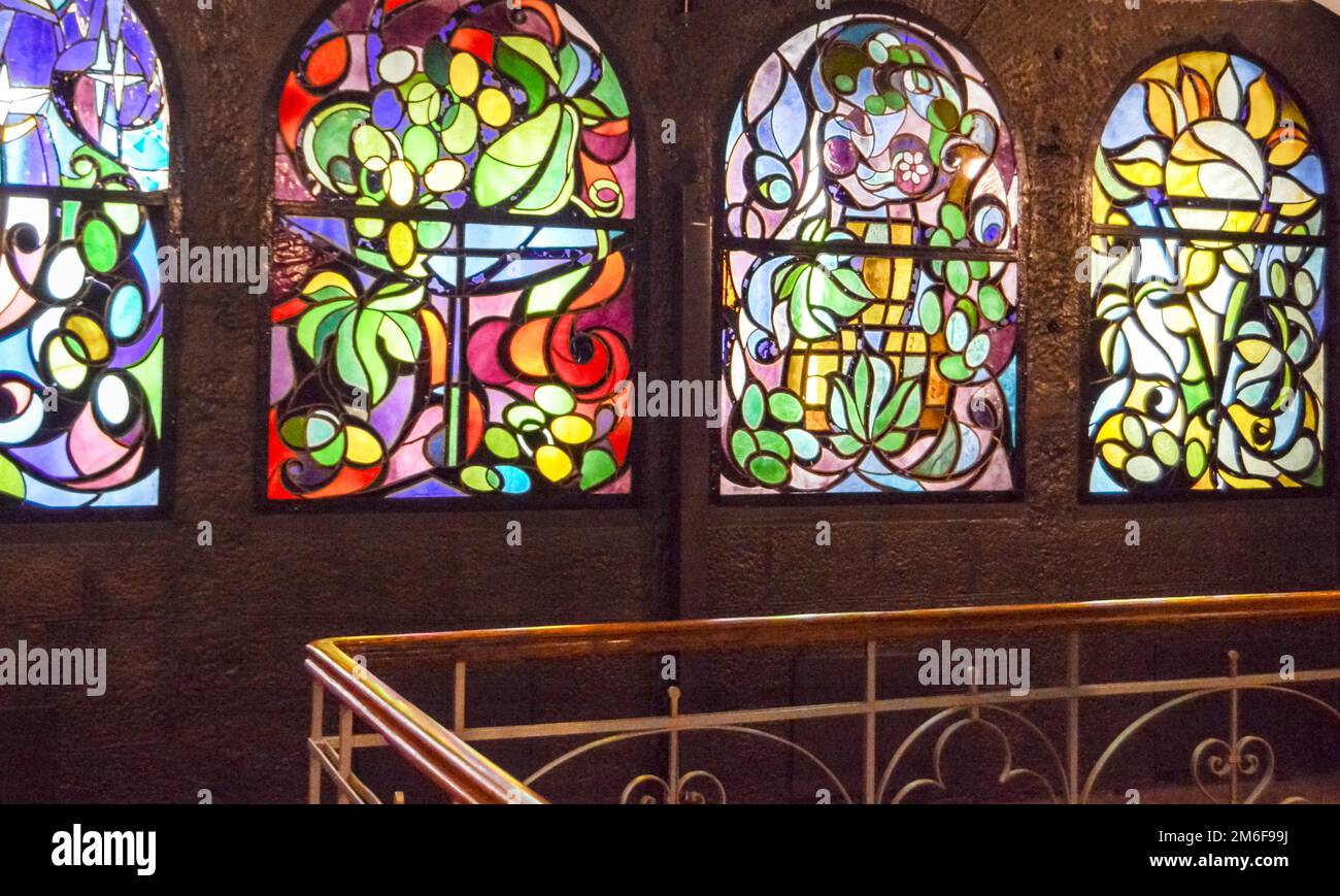 Stained glass windows in a row and a staircase, vintage room interior ...