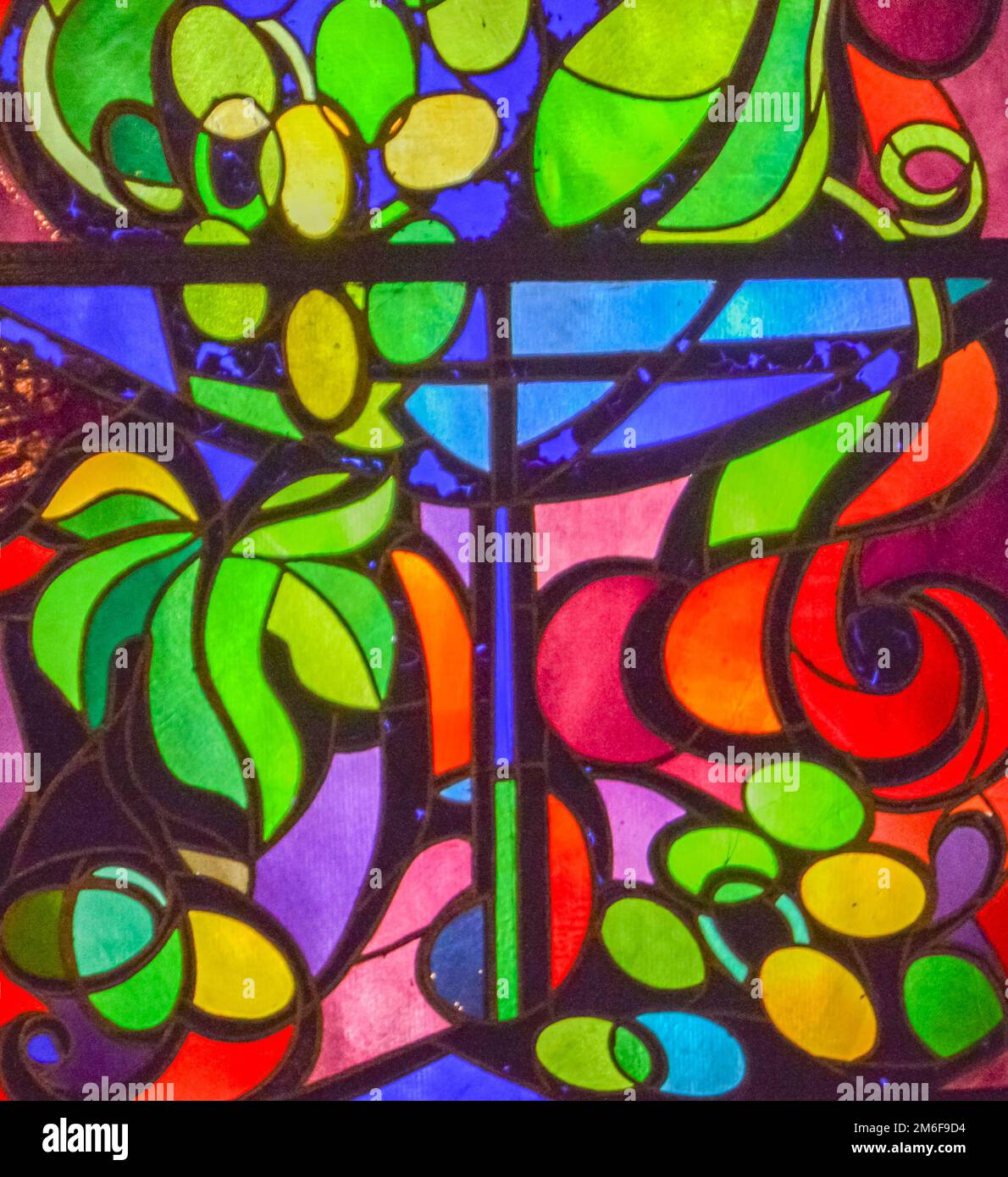 Abstract stained glass background of multicolored glass with floral and ...