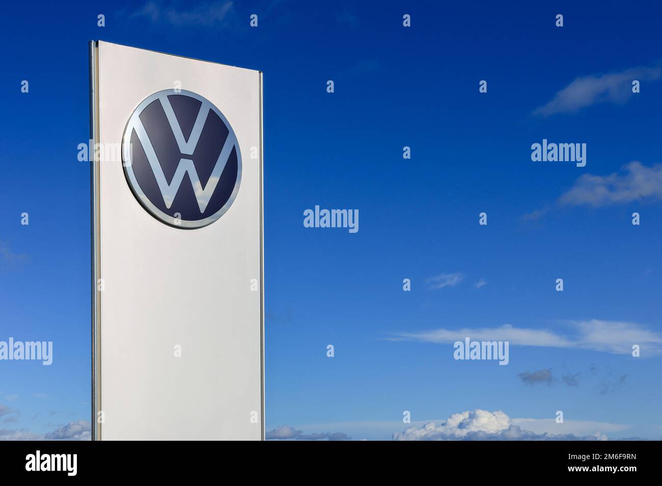 A low angle shot of the Volkswagen service center sign under a blue ...