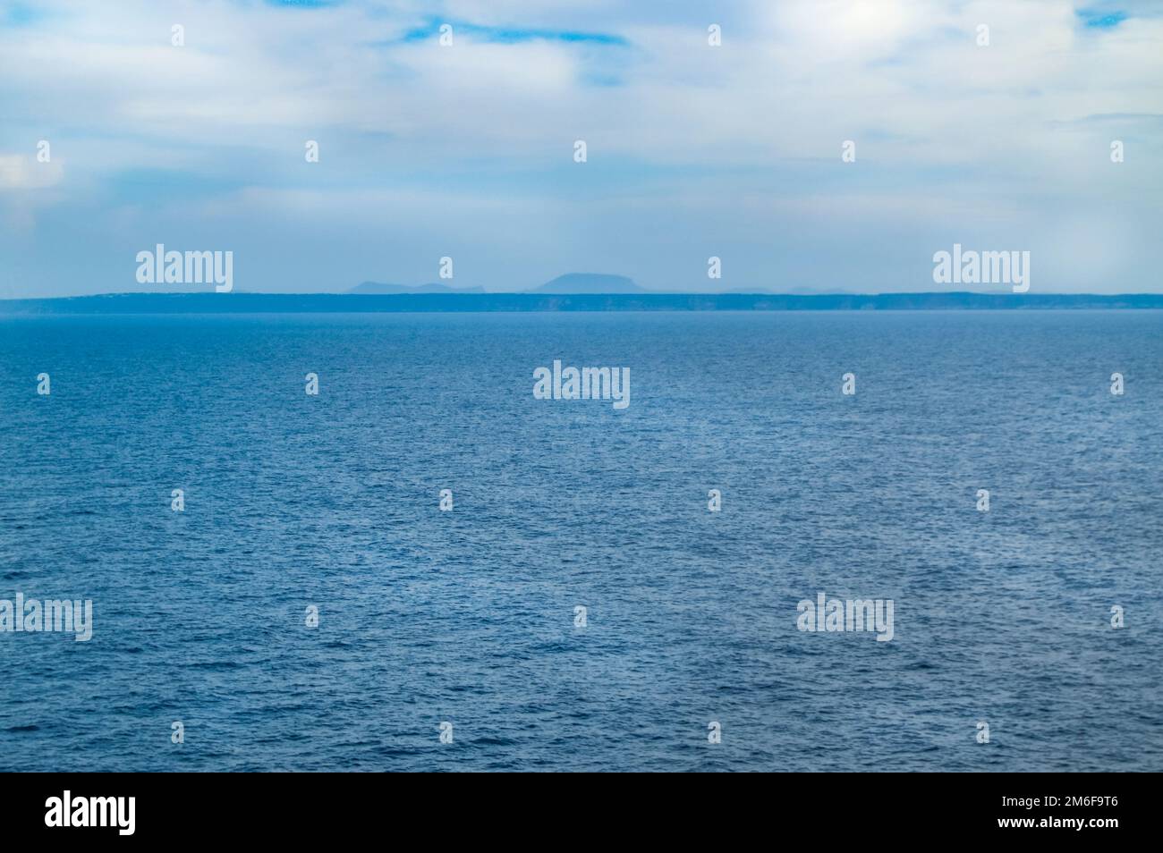 Amazing clouds over the sea in the pre-dawn hour, the horizon line with ...