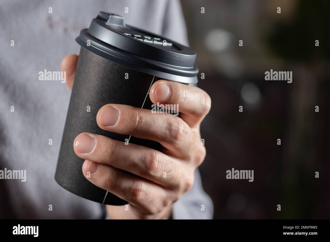 Man drinking coffee from disposable cup close up Stock Photo - Alamy