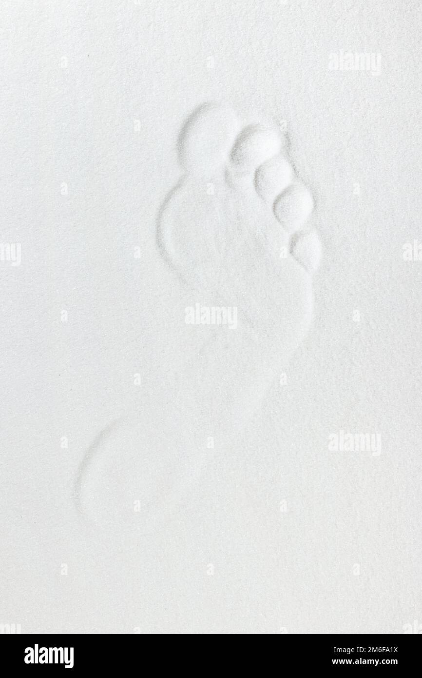 Footprint on the white sand close up Stock Photo - Alamy